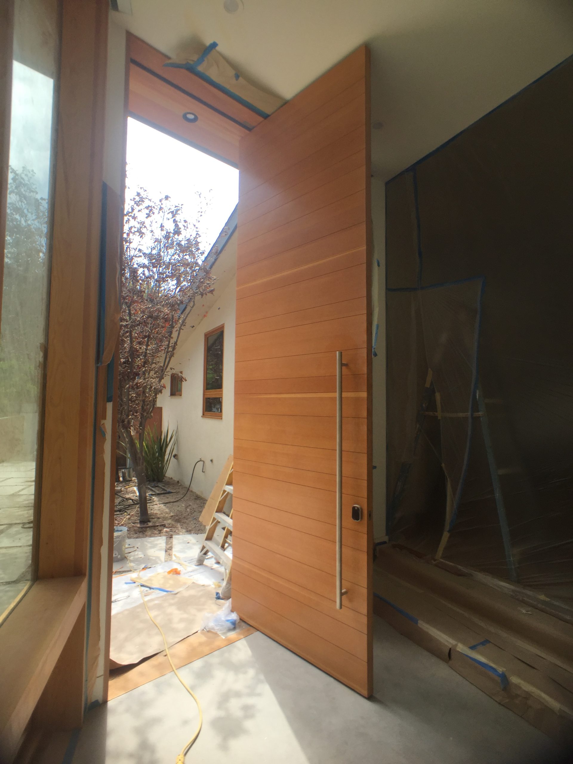 Sophisticated Entry Using a Large, Pivoting Front Door - Krueger Architects